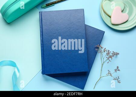 Blank book, cookies and ribbon on color background Stock Photo - Alamy
