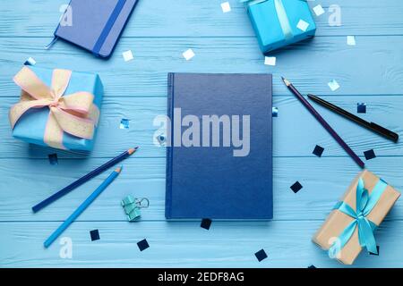 Composition with blank notebook, pencils and Christmas decor on color ...