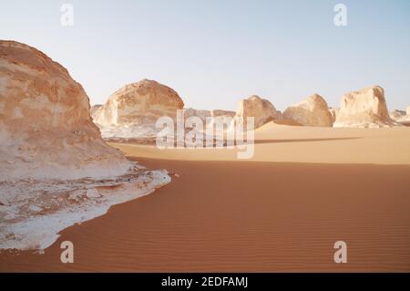 White chalk rock formations and sand on the desert floor in White ...