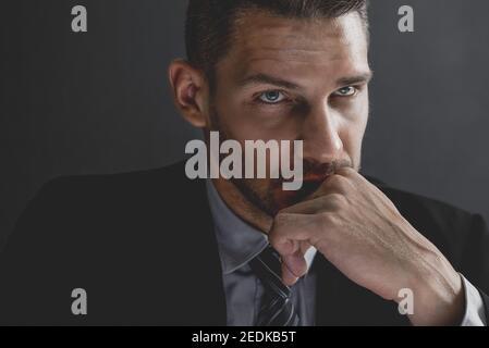 Man in shadow staring at interlocutor, criminal interrogation concept ...