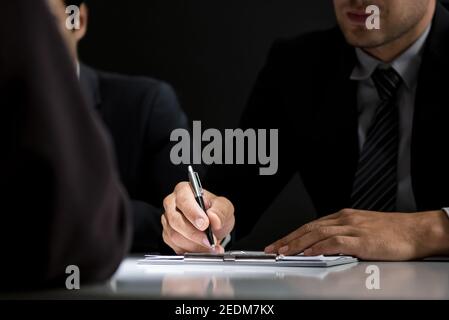Interrogator taking note while interviewing suspect in the ...