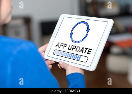 Tablet screen displaying an app update concept Stock Photo - Alamy