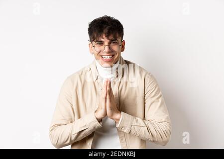 Handsome caucasian man say thank you, bowing with namaste gesture ...