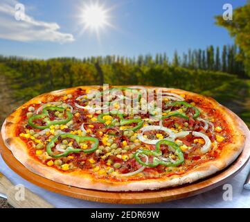 Pizza with corn, bacon, chili, onion, pea Stock Photo - Alamy
