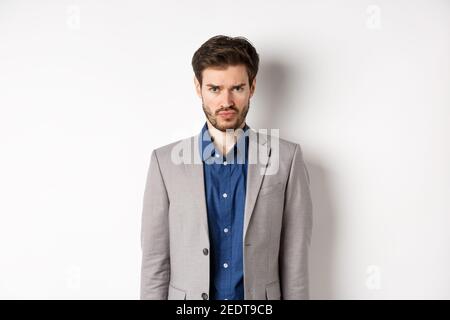 Sad offended guy sulking, wearing business suit, feel something unfair ...