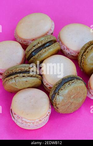 Homemade chocolate raspberry macaron cookies on parchment paper on a ...