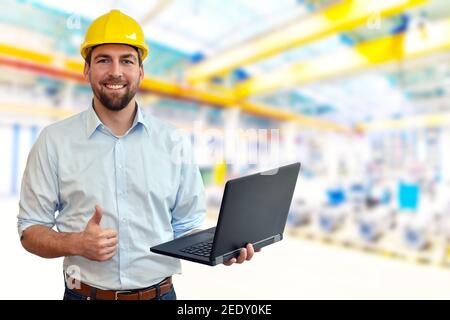 engineer at his workplace with notebook in an industrial company in ...