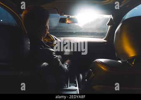 Young caucasian man inside a car using a smartphone Stock Photo - Alamy