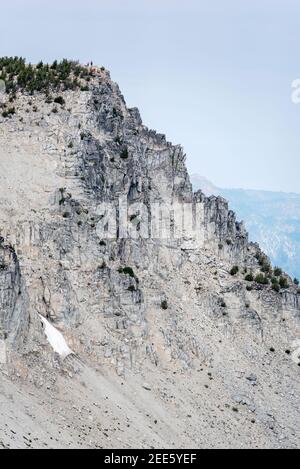 Hiker on the summit of Eagle Cap overlooking the East Lostine River ...