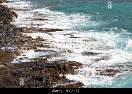 Waves crashing onto lava rock in Hawaii Stock Photo - Alamy