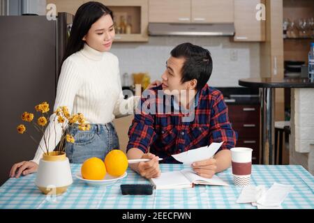 Young family in budget planning concept Stock Photo - Alamy