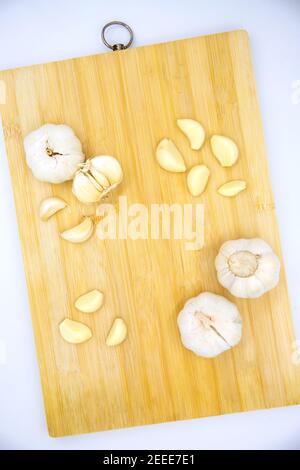 Top view of cleaned organic garlic and a spoon on the napkin over the ...