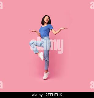Happy young asian lady jumping at studio Stock Photo - Alamy