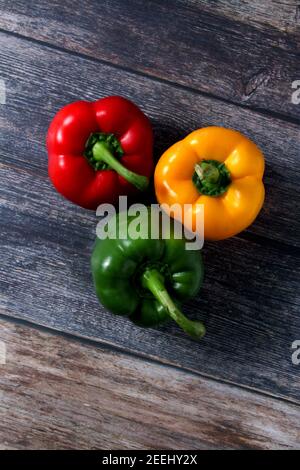 Top view of colorful bell peppers and green spicy peppers on a white ...
