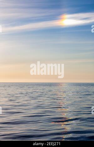 A beautiful scene of the sun halo phenomenon with blue sky and white ...