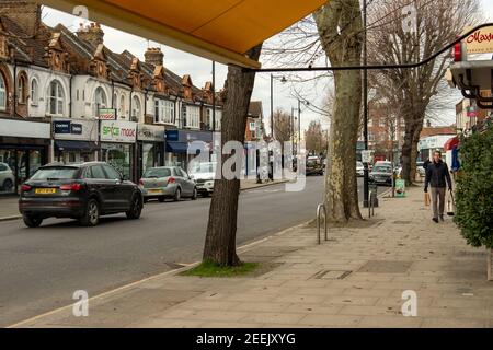 London- Northfields high street, a long street of shops on residential ...
