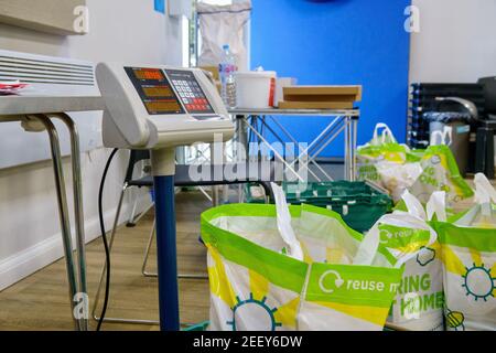 Weighing food donations on weight scales in a Trussell Trust foodbank ...