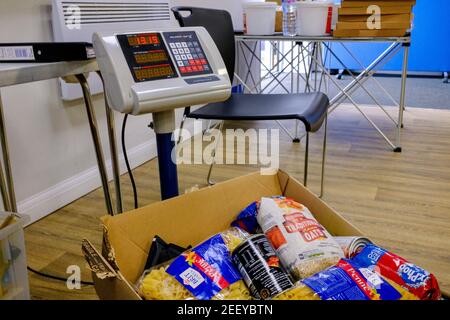 Weighing food donations on weight scales in a Trussell Trust foodbank ...