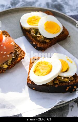 Toasted breads with boiled egg and avocado. Guacamole sandwiches ...