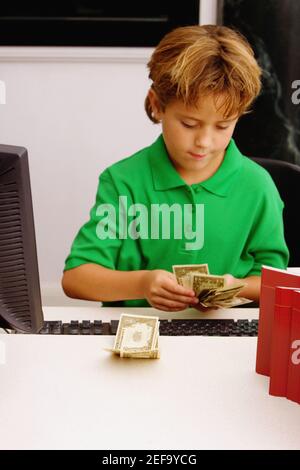 Boy counting currency notes Stock Photo - Alamy