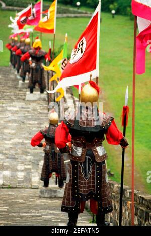 A sculpture of a soldier in a suit of armour with a dragon at his feet ...