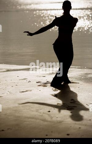 Silhouette of people exercising on the edge of Rio Vermelho beach in ...