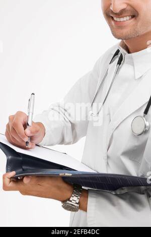 Midsection of caucasian male doctor with stethoscope, pen and ...