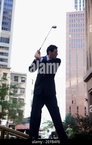 Young hispanic man holding golf ball smiling with a happy and cool ...