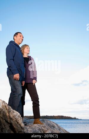 Full length of romantic multiracial senior couple dancing in kitchen at ...