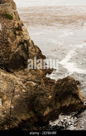 water flowing from the rocks into the ocean on the coastline Stock ...