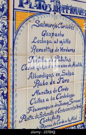 Sign with restaurant menu on the tiled sidewalk Stock Photo - Alamy