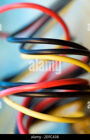 Red, black and yellow cables tangled across a white background. Network ...