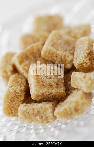 selective focus of brown sugar cubes in wooden tray Stock Photo - Alamy