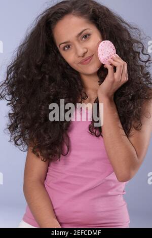 Cheerful young woman holding bath loofah sponge Stock Photo - Alamy