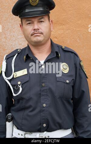 1, one, Mexican policeman police officer on duty making eye contact in ...