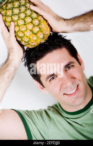 Portrait of a man with a pineapple on his head Stock Photo - Alamy