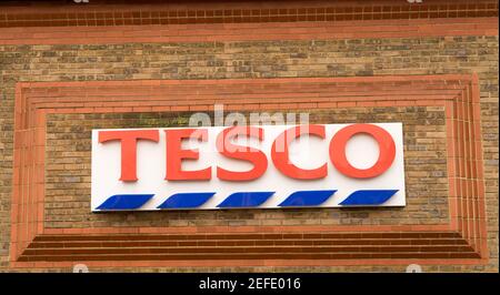 Tesco lettering engraved into red brick wall Stock Photo - Alamy