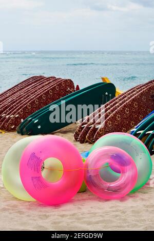 Inflatable rings and surfboards on the beach, Waikiki Beach, Honolulu ...