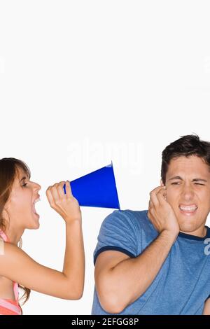 Young hispanic woman holding megaphone doing ok sign with fingers ...