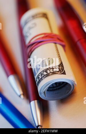 Close-up of Rolled banknote tied with red ribbon Stock Photo - Alamy