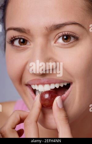 Young Woman Eating Red Grape Model Released Stock Photo - Alamy