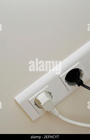 Two sockets with plugs inside Stock Photo - Alamy