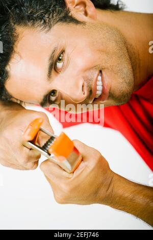 Portrait of a young man holding a clamp Stock Photo - Alamy