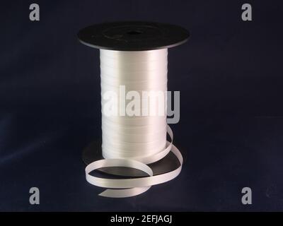 Glossy gift strings on plastic reels Stock Photo - Alamy