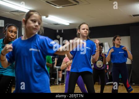 Schoolchildren participate in an indoor Physical Education (PE) lesson ...