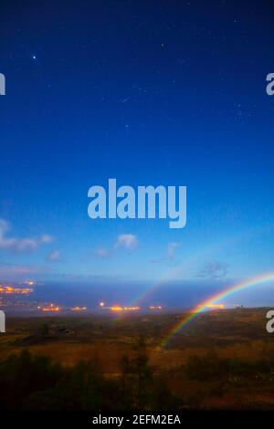Moonbow appears over the Kohala Coast in the night at Big Island Hawaii ...