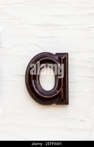 Dark brown glazed letter ü on a light wall Stock Photo - Alamy