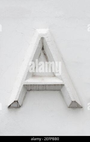 White stucco letter T on white ground Stock Photo - Alamy