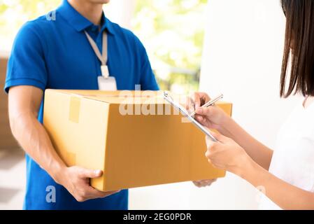 woman receive package from delivery man. male postal courier person ...