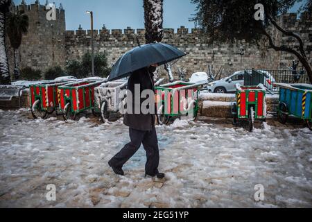 Jerusalem. 18th Feb, 2021. A man walks near the Dome of the Rock after ...